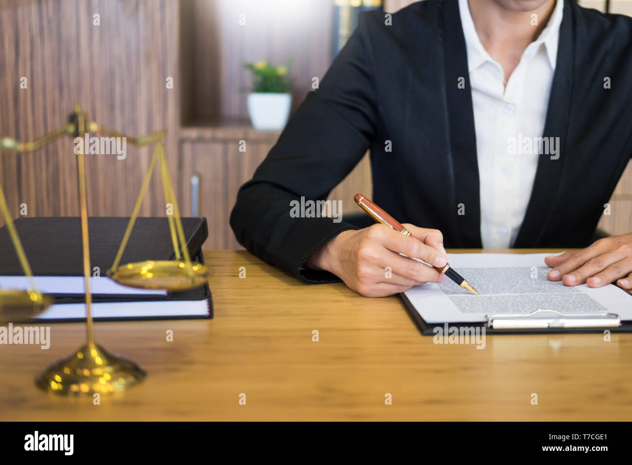 lawyer judge reading documents at desk in courtroom working on wooden ...