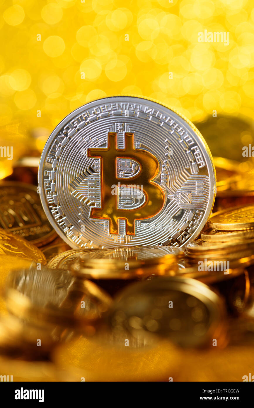 Bitcoin on pile of golden coins, big silver coin with gold Bit symbol ...