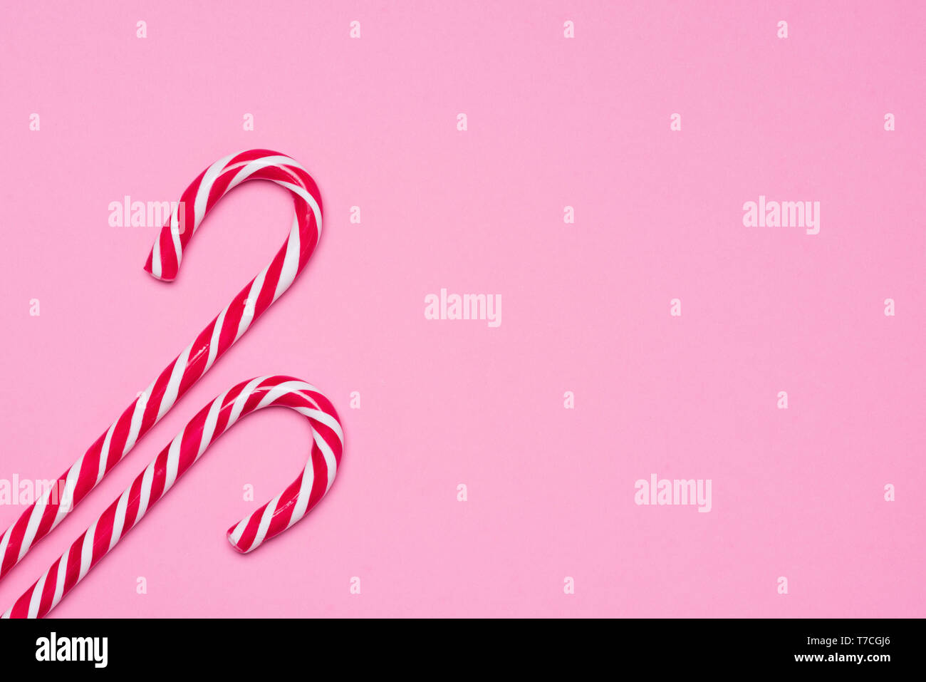 Two candy canes on pink background top view with copy space Stock Photo ...