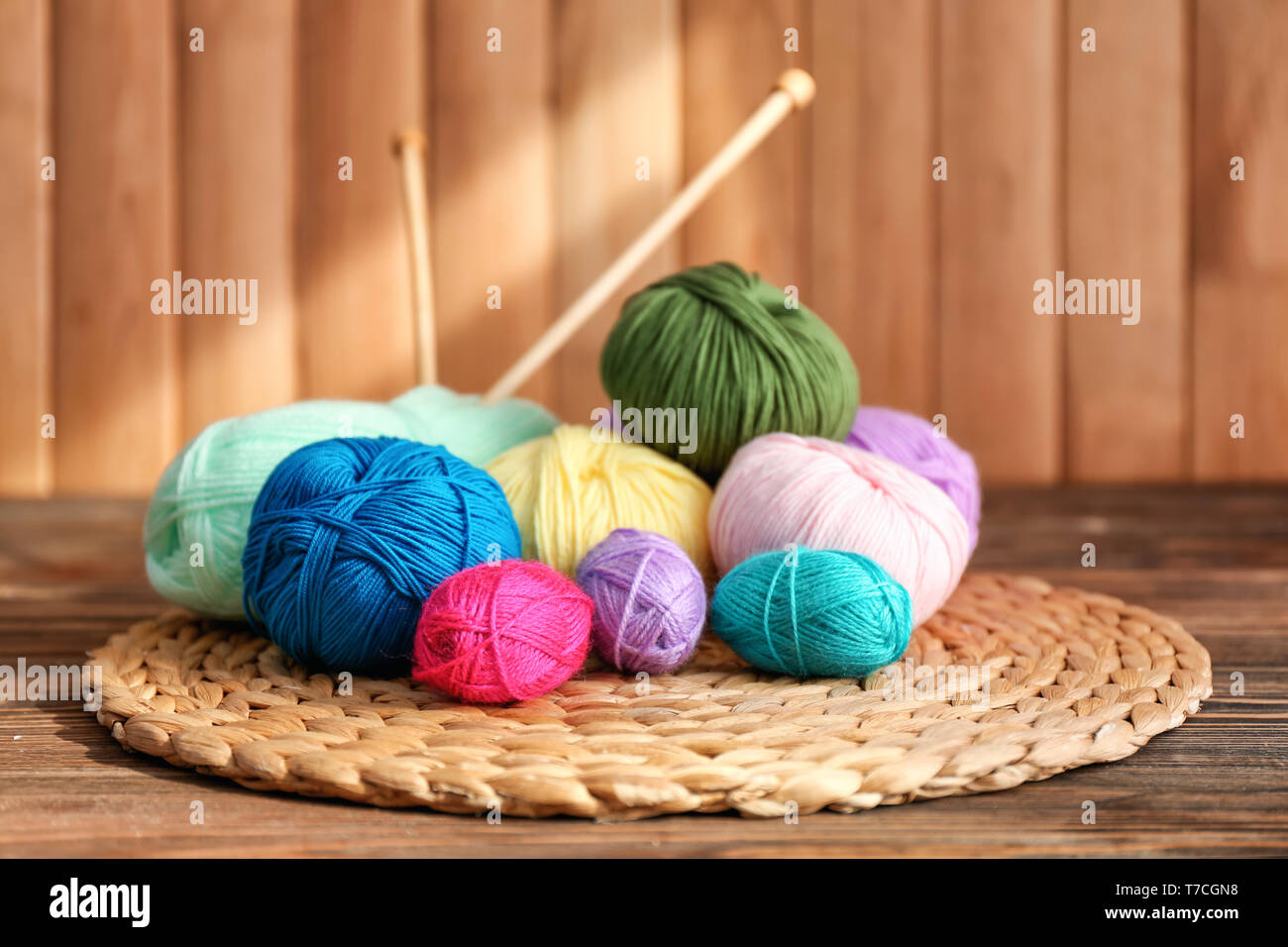 Colorful knitting yarn on wicker mat Stock Photo - Alamy