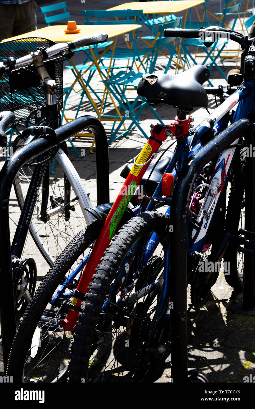 Bicycles chained to bike parking rack located in City centre shopping ...