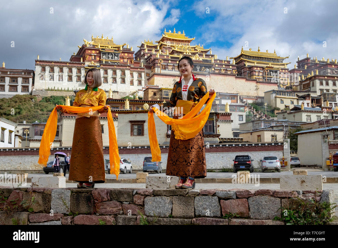 Songzanlin Tibetan Buddhist Monastery reflected in sacred lake, Shangri ...
