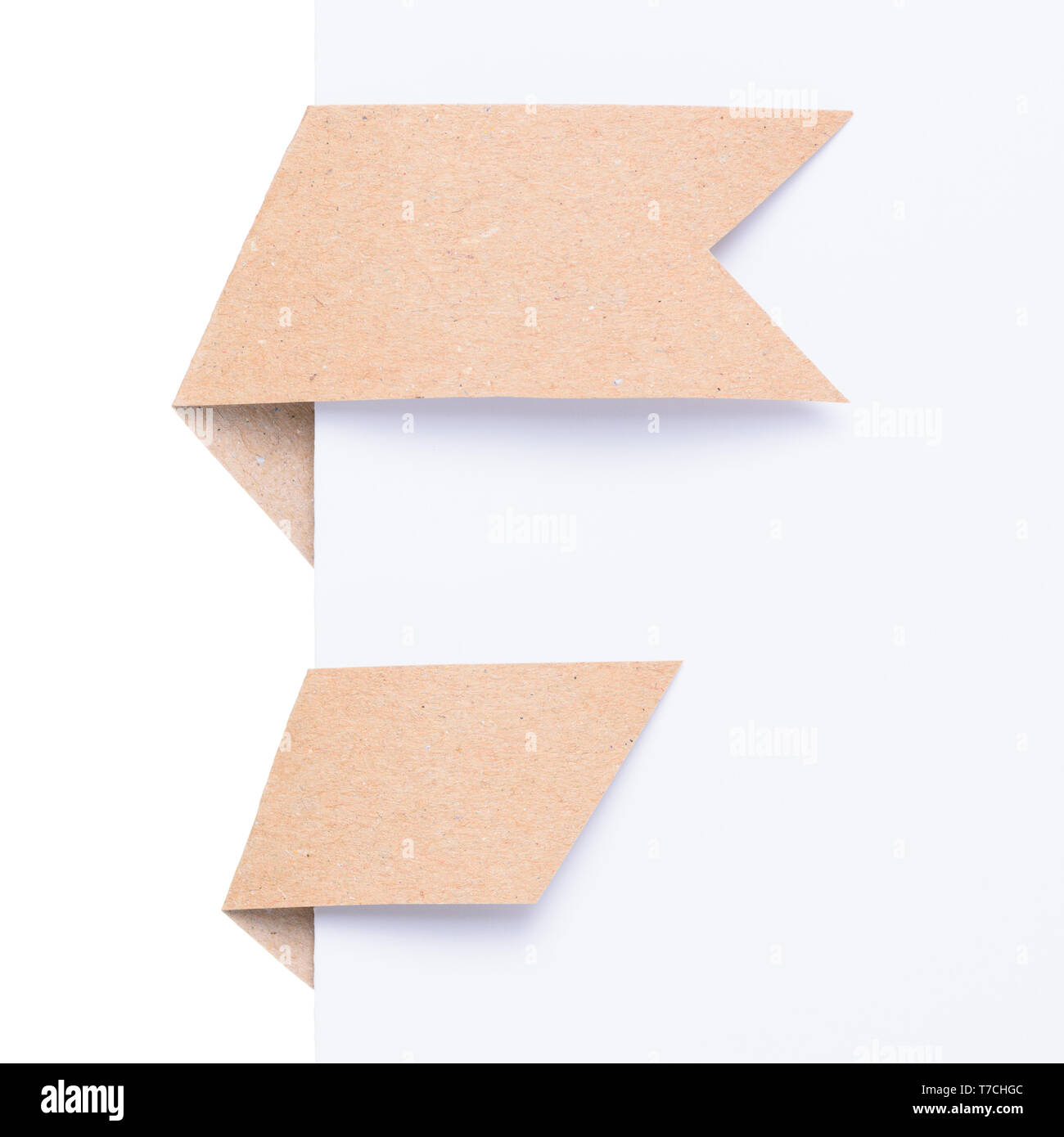 Two curved ribbons from ecological recycled paper bend over white paper ...