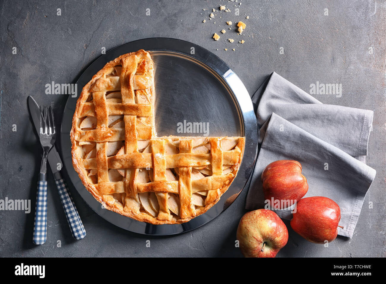 Plate with tasty homemade apple pie and fresh fruit on table, top view ...