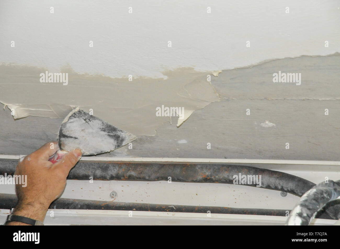 Home care. a room is being re plastered using a Putty knife. The ...