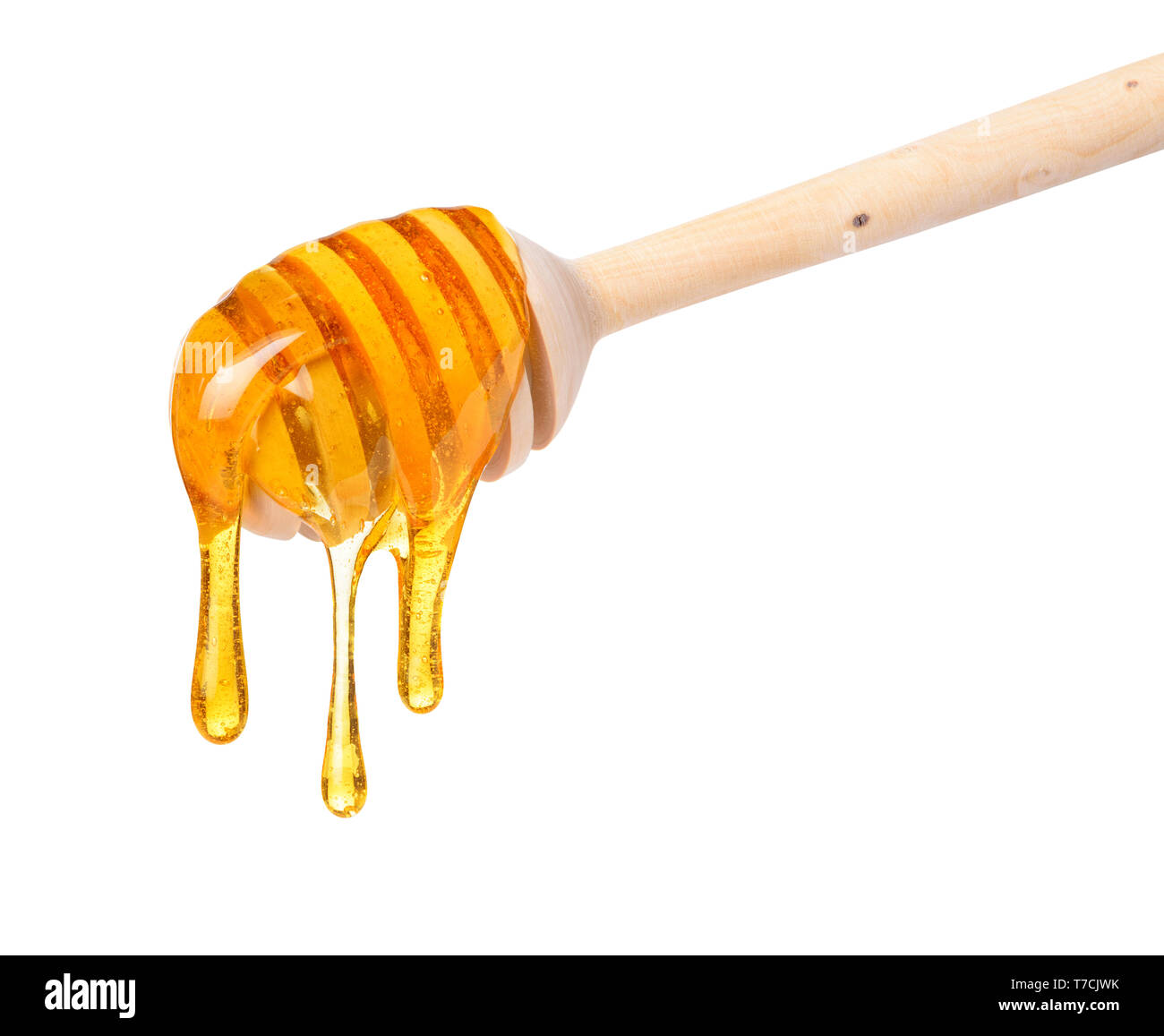 Rich honey dripping from wooden dipper spoon isolated on white ...