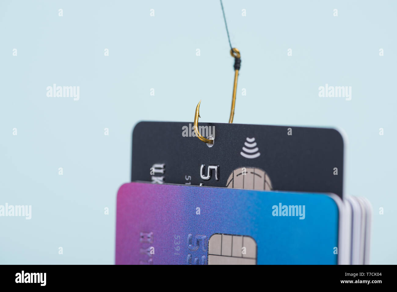 One credit card being stolen by fishing hook from stack of other bank ...