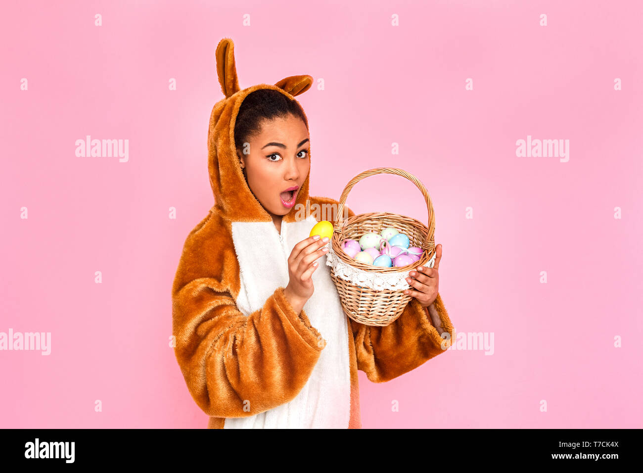 Young Woman In Bunny Kigurumi Standing Isolated On Pink Background