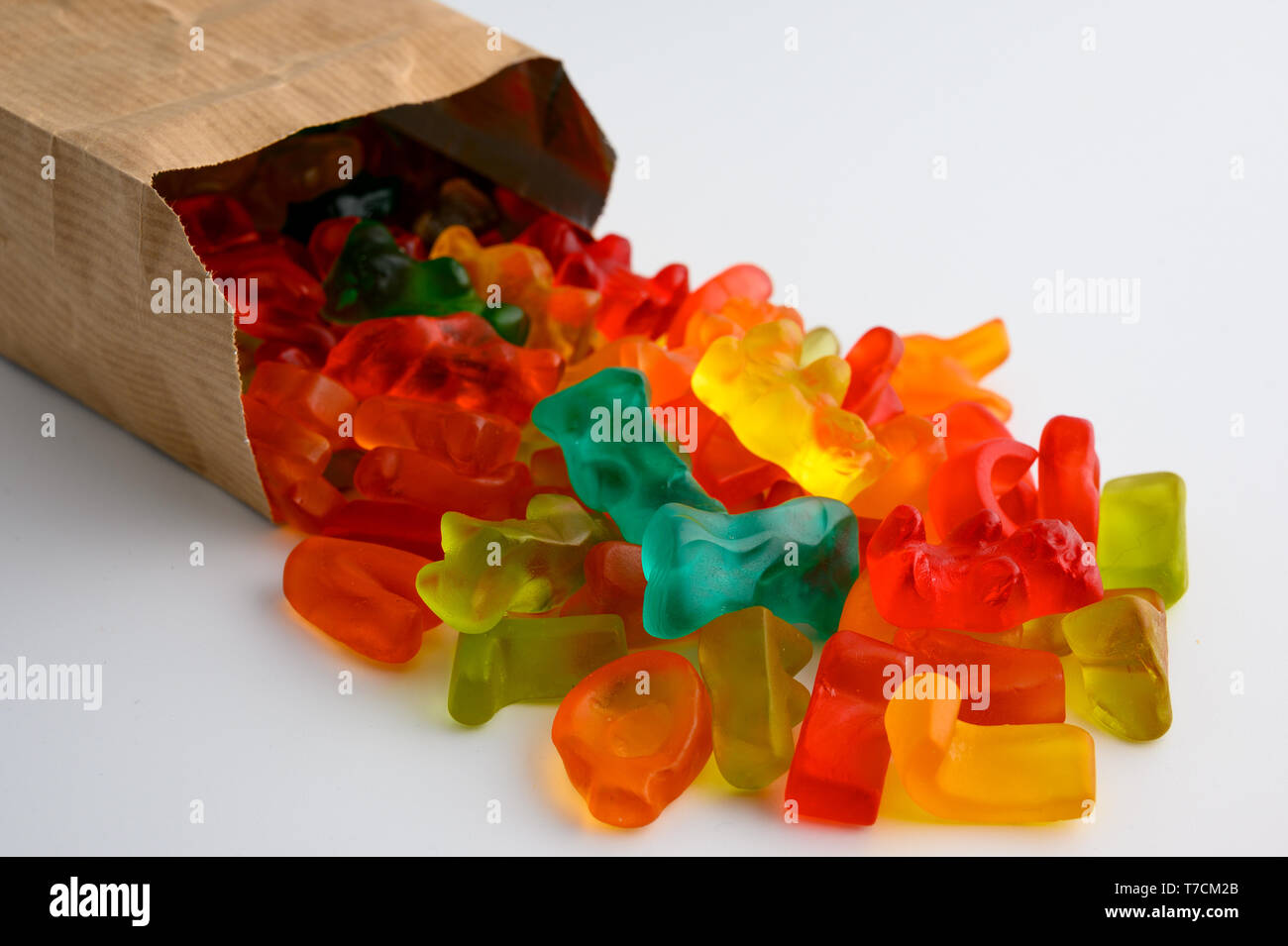 Paper bag of colorful gummy candies on white background Stock Photo - Alamy