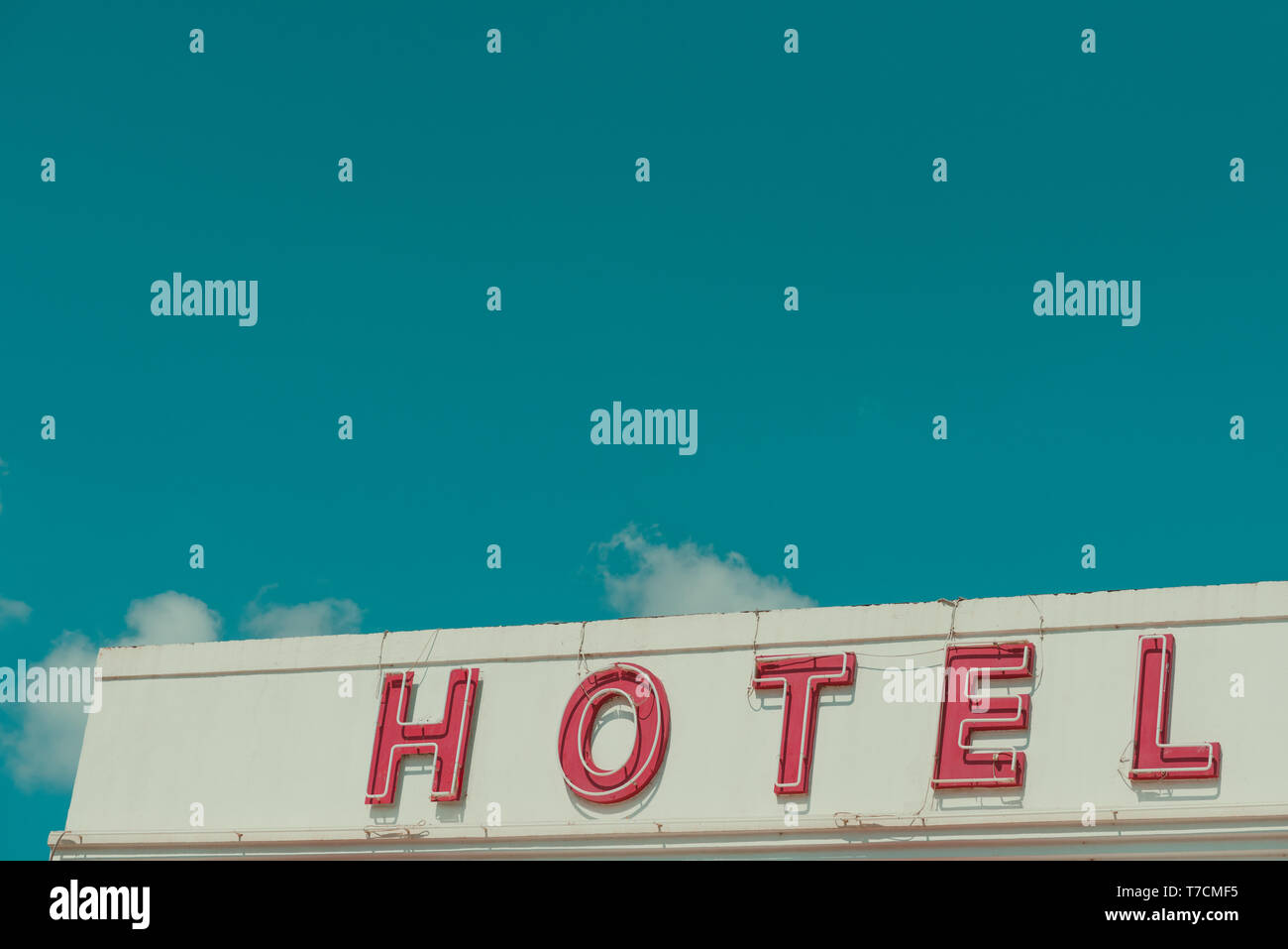 Hotel vintage neon sign text on old building with sky copy space retro ...