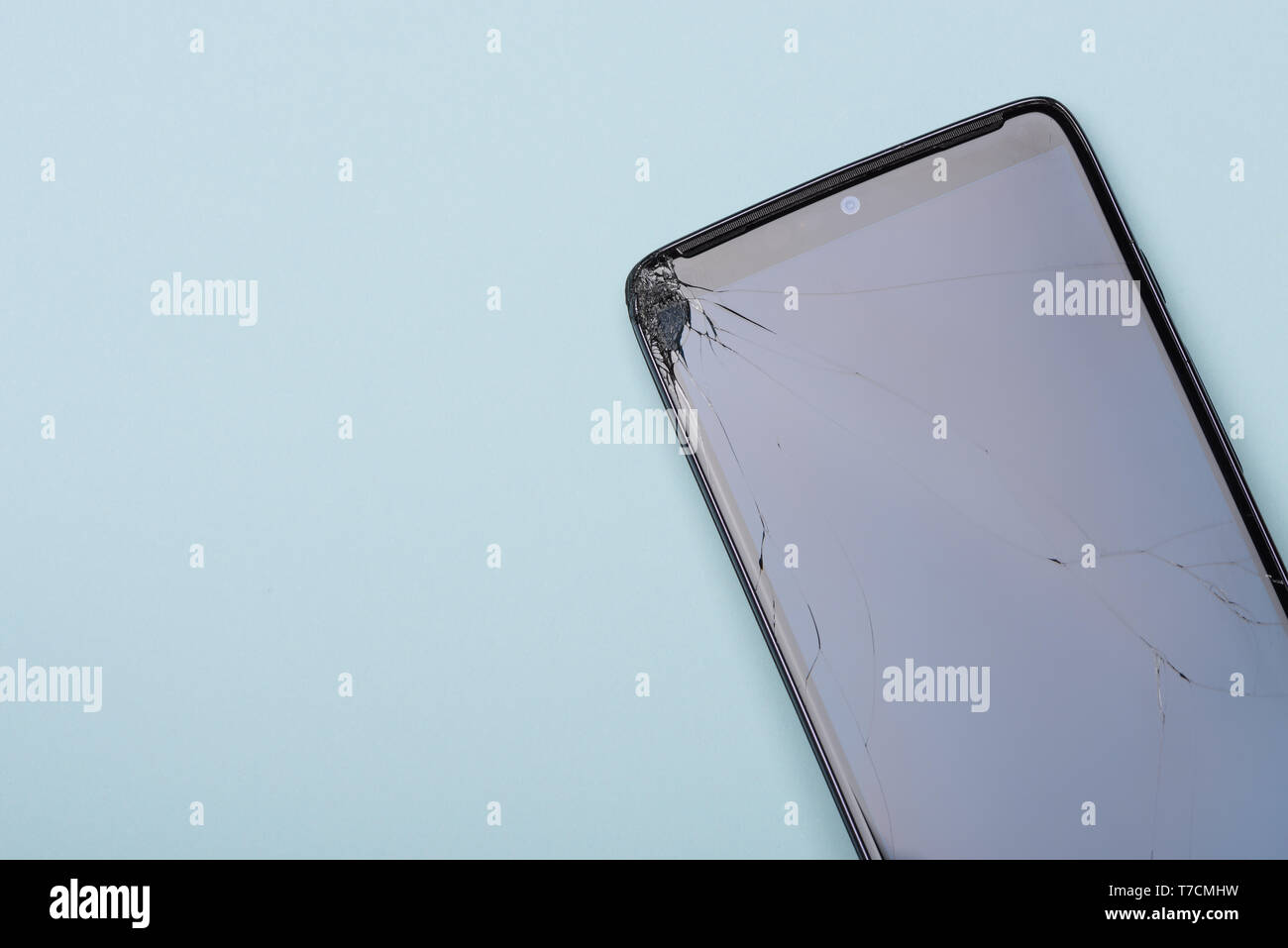 Smartphone with broken glass screen phone touch screen on blue ...
