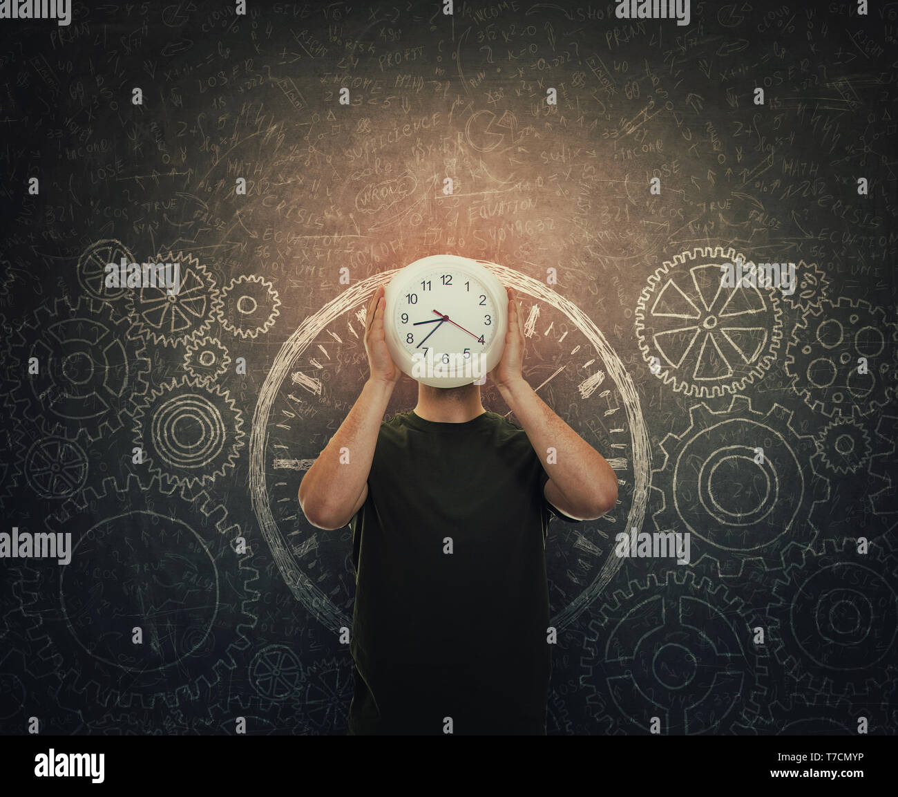 Guy hiding face holding a clock instead of head stands over dark ...