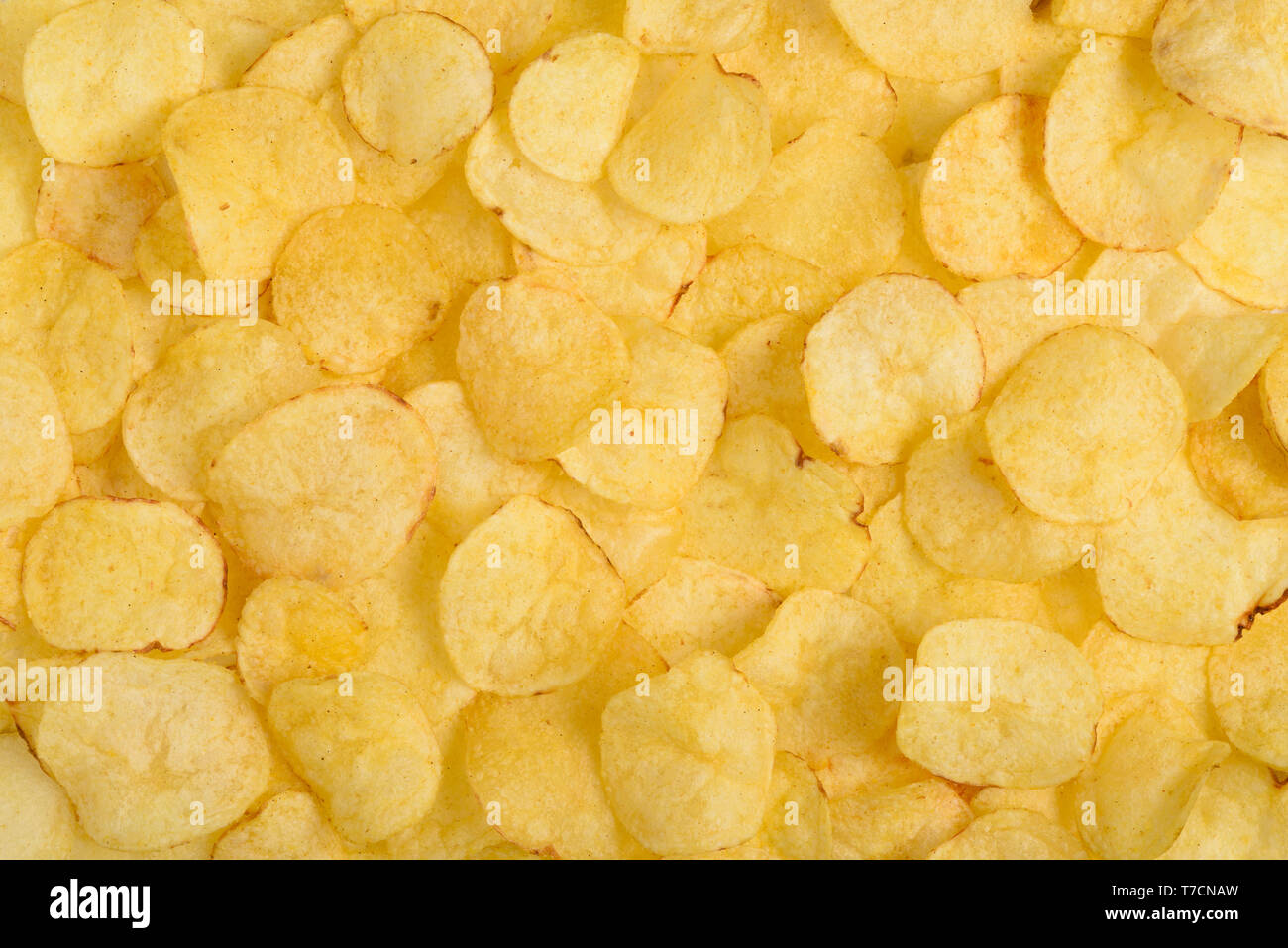Crispy potato chips texture background top view Stock Photo - Alamy