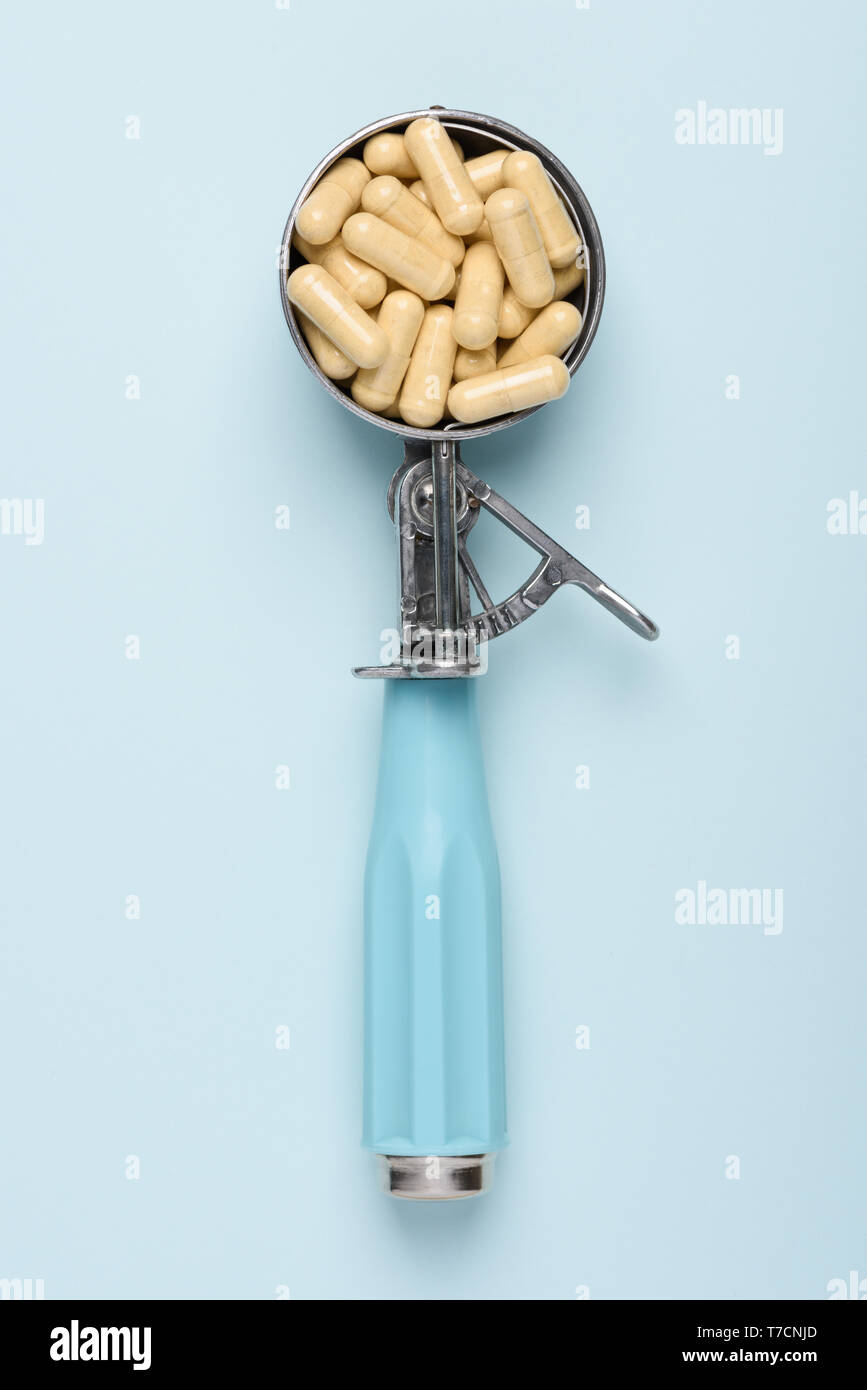 Vintage Ice cream scoop filled with medical drugs capsules concept ...