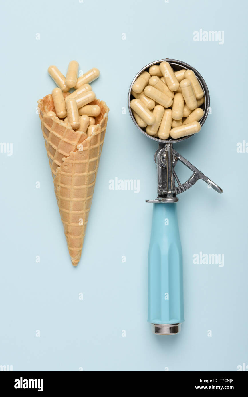 Ice cream waffer cone and scoop with medical drugs concept flat lay ...