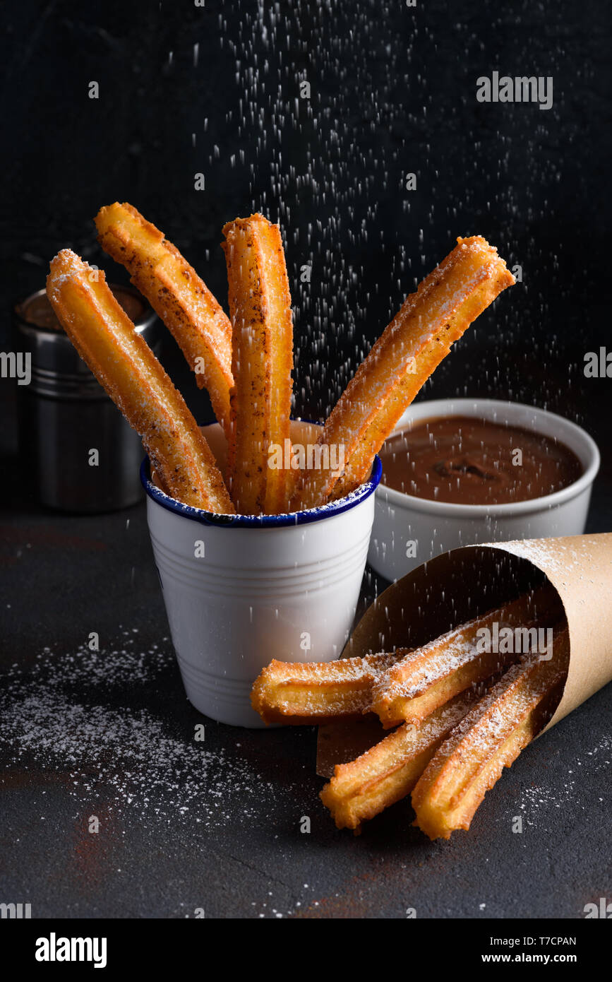 Traditional churros sticks with cinnamon sprinkling with sugar powder ...