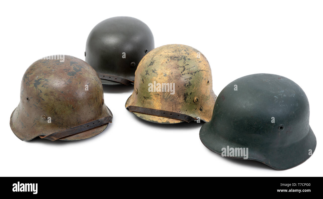 four German World War Two (Stahlhelm) military helmets isolated on ...