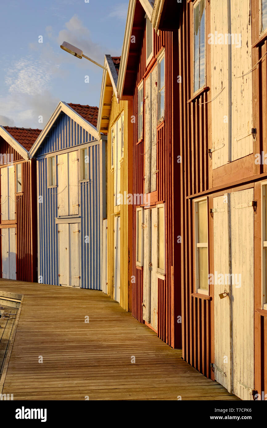 Colourfully painted timber traditional fishing boat huts / cabins in ... Colourfully painted timber traditional fishing boat huts / cabins in ...