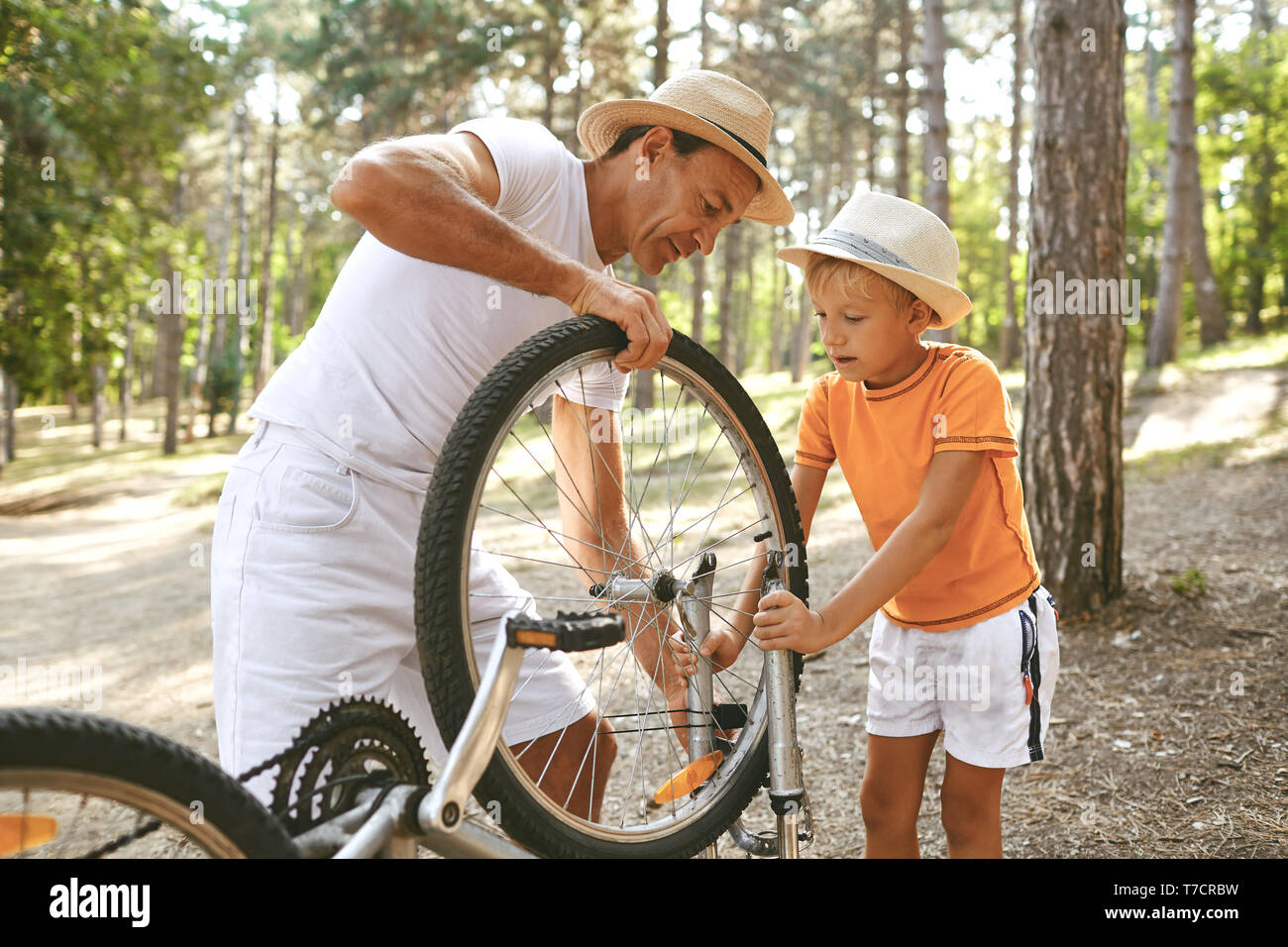 Father and son repairing bicycle hi-res stock photography and images ...