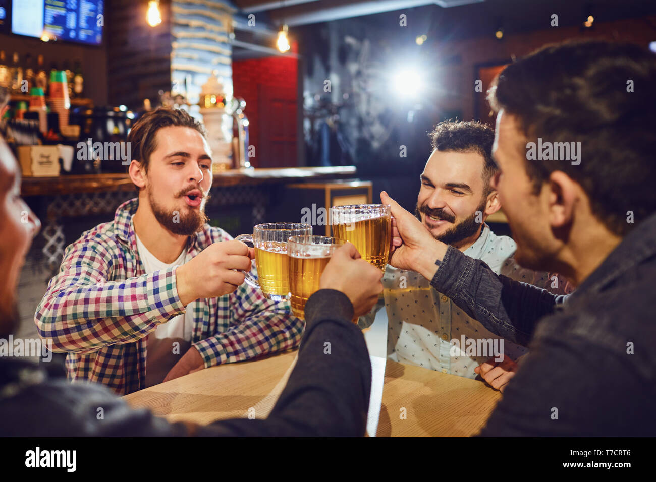 Friends talk, drink beer in a bar Stock Photo - Alamy