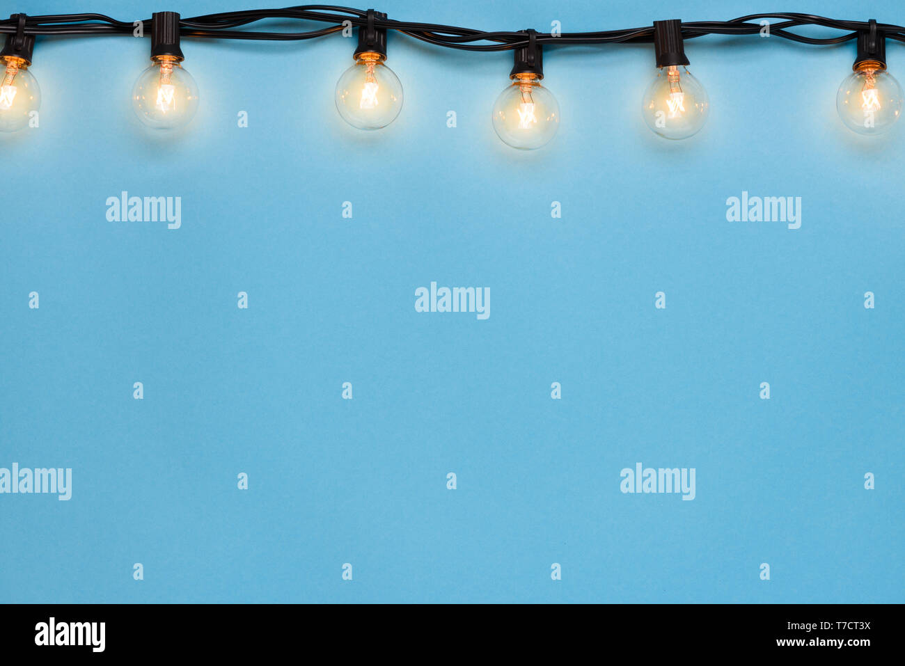 Light bulb string light on blue background copy-space Stock Photo - Alamy