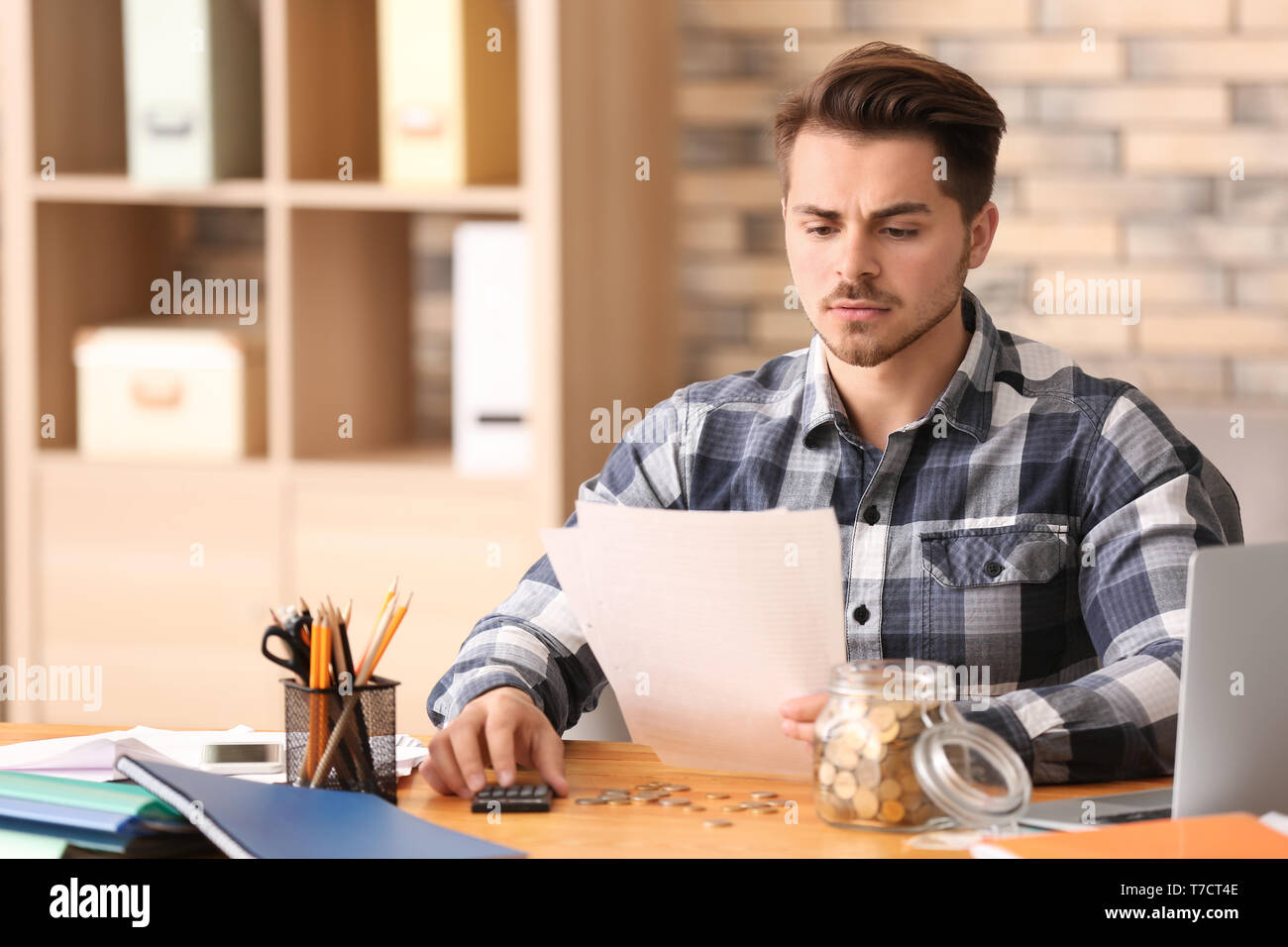Young man counting money at table indoors Stock Photo - Alamy