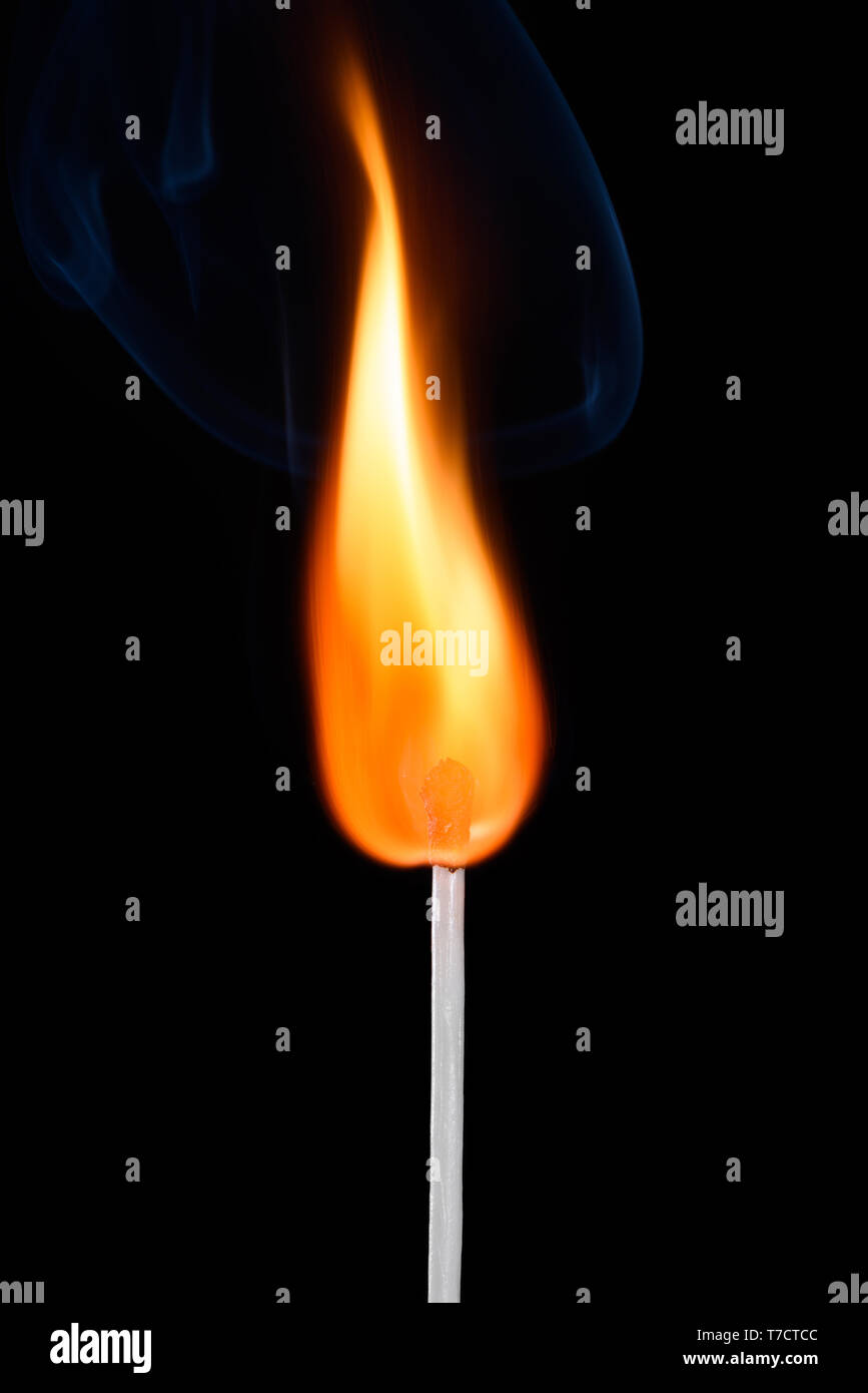 Bright burning match stick with fire and smoke isolated on black ...