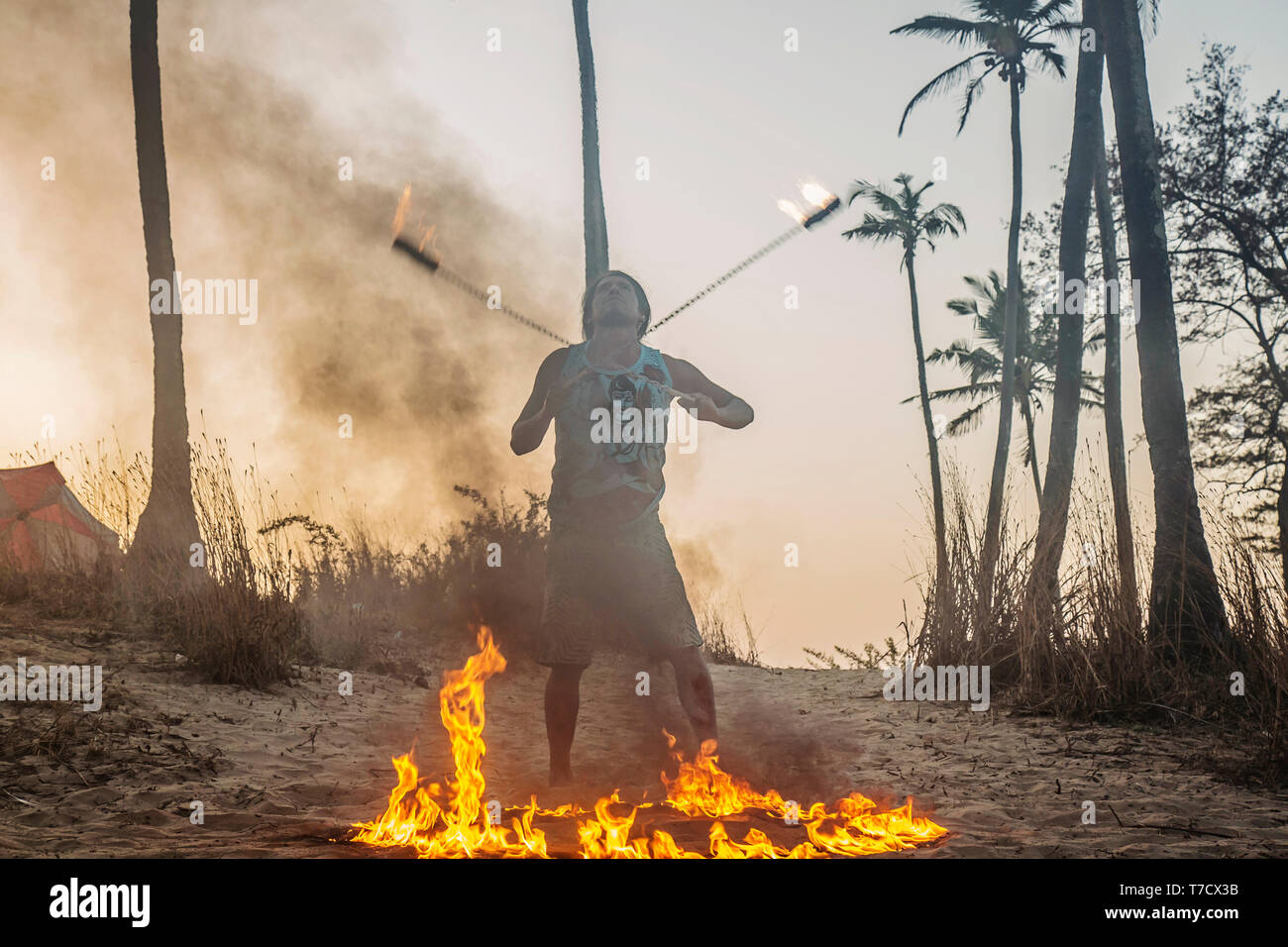 Man doing fire show at Arambol beach in India Stock Photo - Alamy