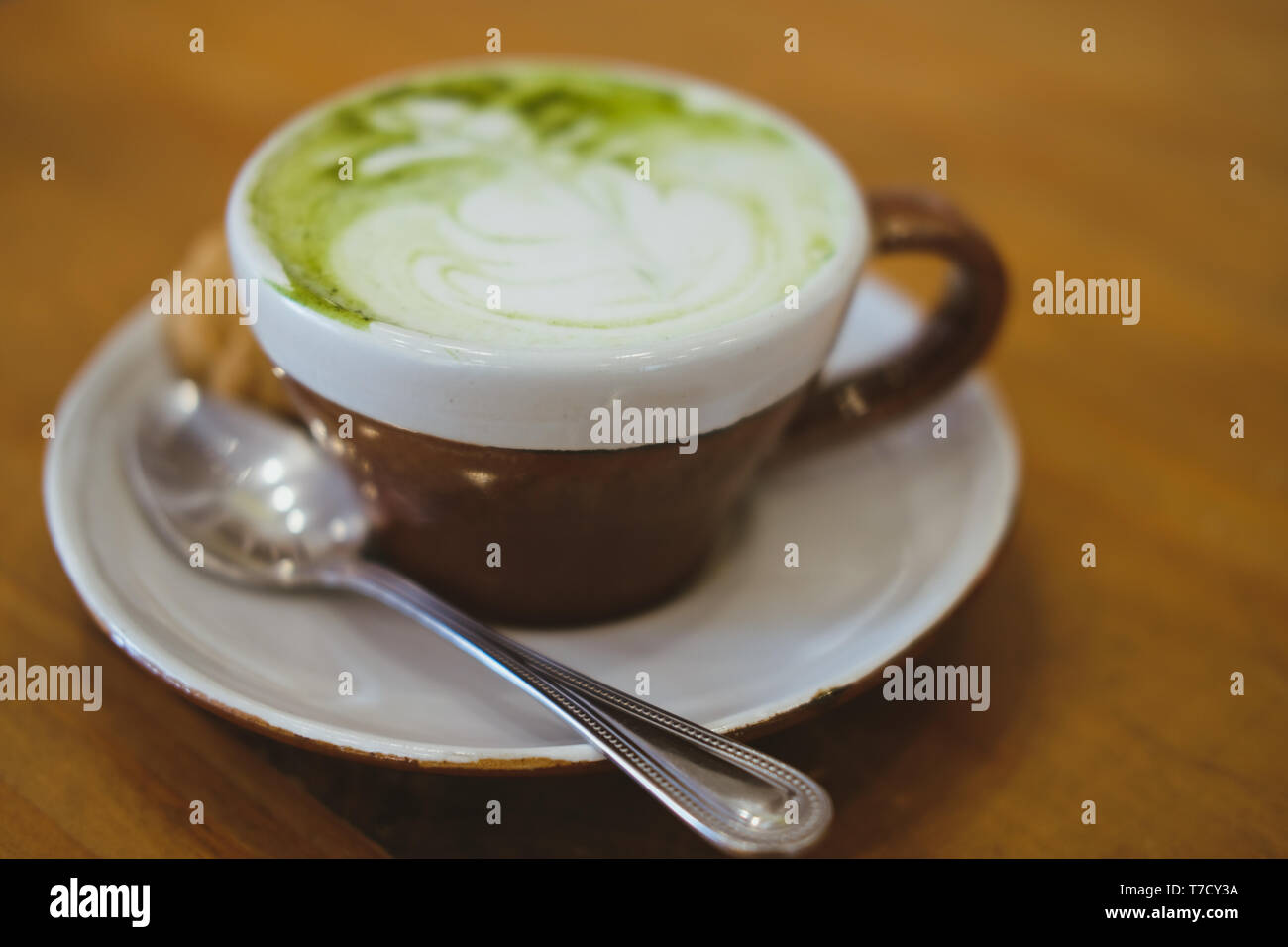 hot matcha green tea latte on wood table. delicious beverage Stock ...