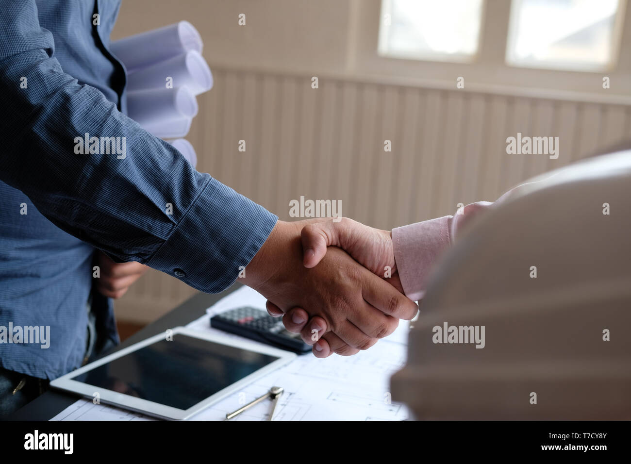engineer handshaking. architect shaking hands for successful deal in ...