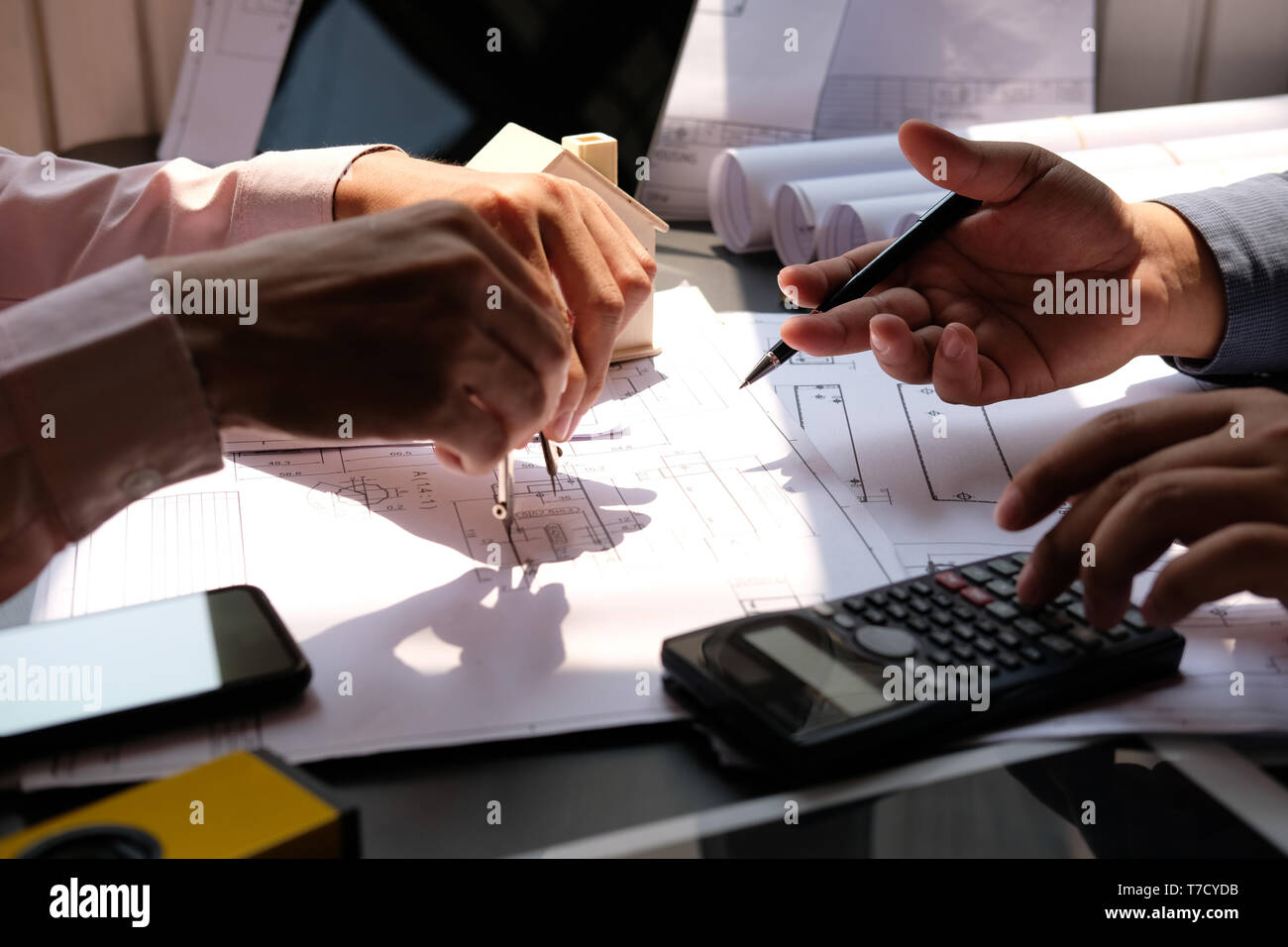 architect engineer team working on house blueprint of real estate ...