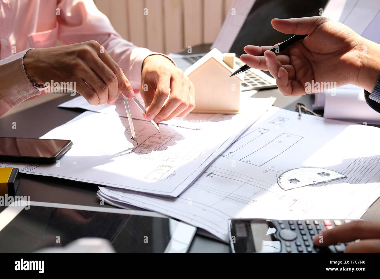 architect engineer team working on house blueprint of real estate ...