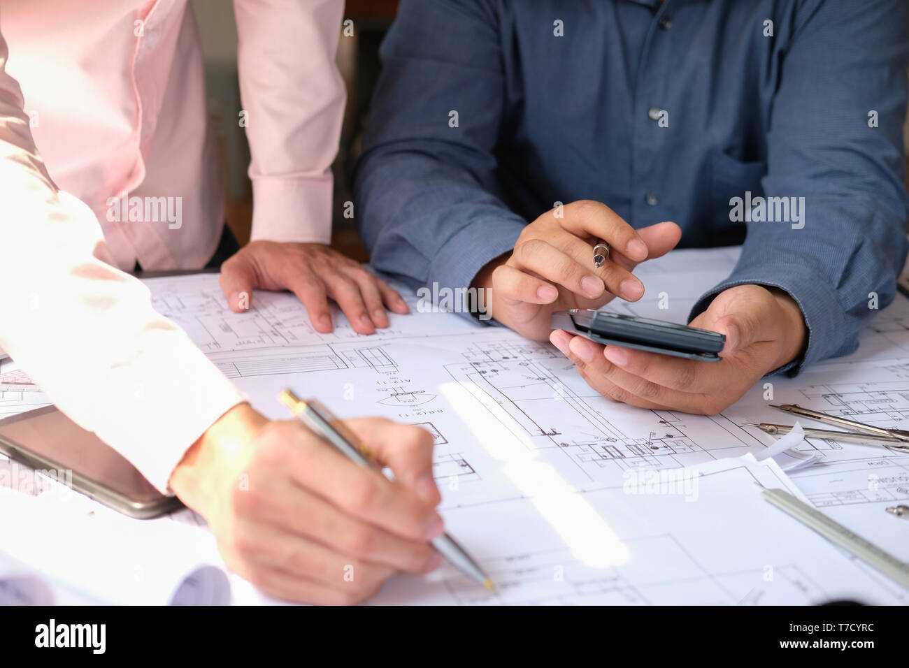 architect engineer team working on house blueprint of real estate ...