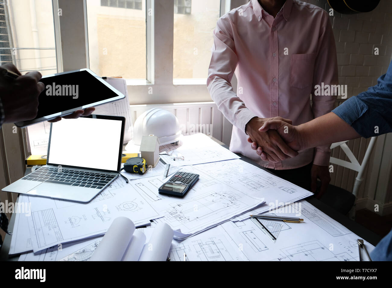 engineer handshaking. architect shaking hands for successful deal in ...