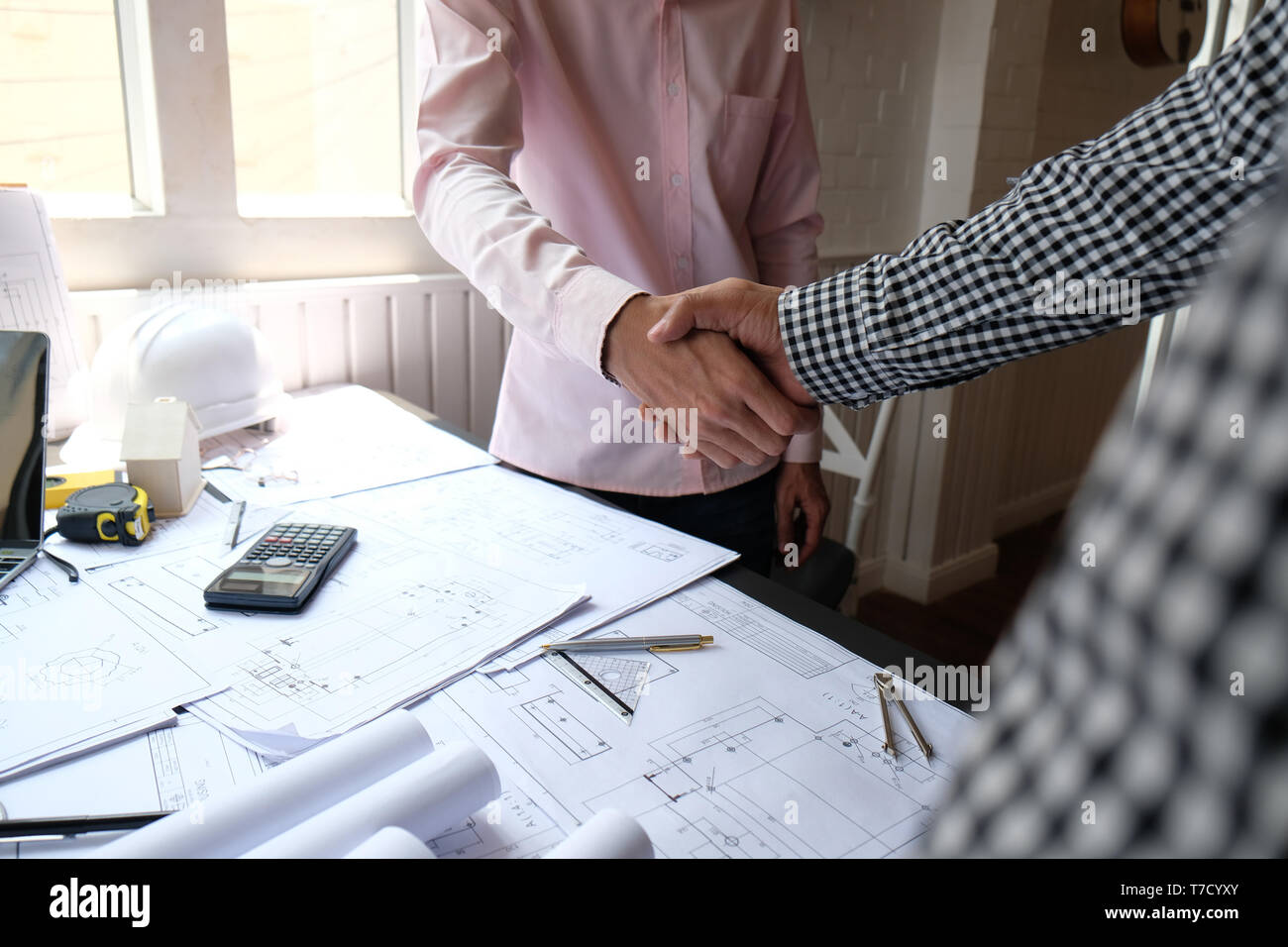 engineer handshaking. architect shaking hands for successful deal in ...