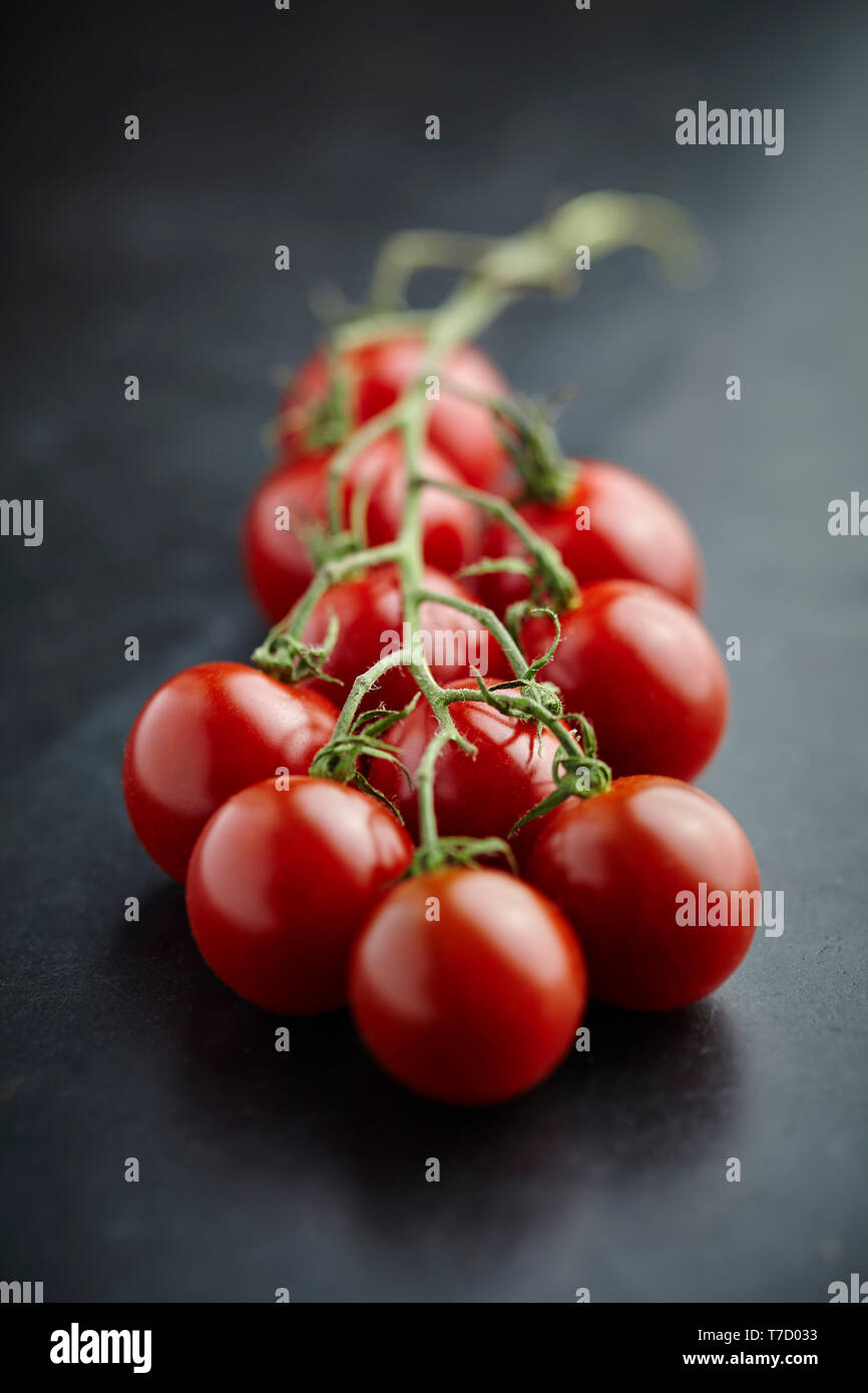 fresh baby tomatoes on the vine Stock Photo - Alamy