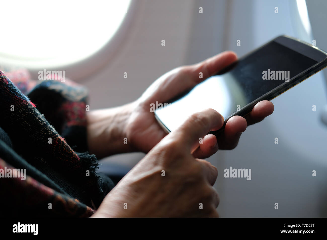 hand holding mobile smart phone on airplane Stock Photo - Alamy