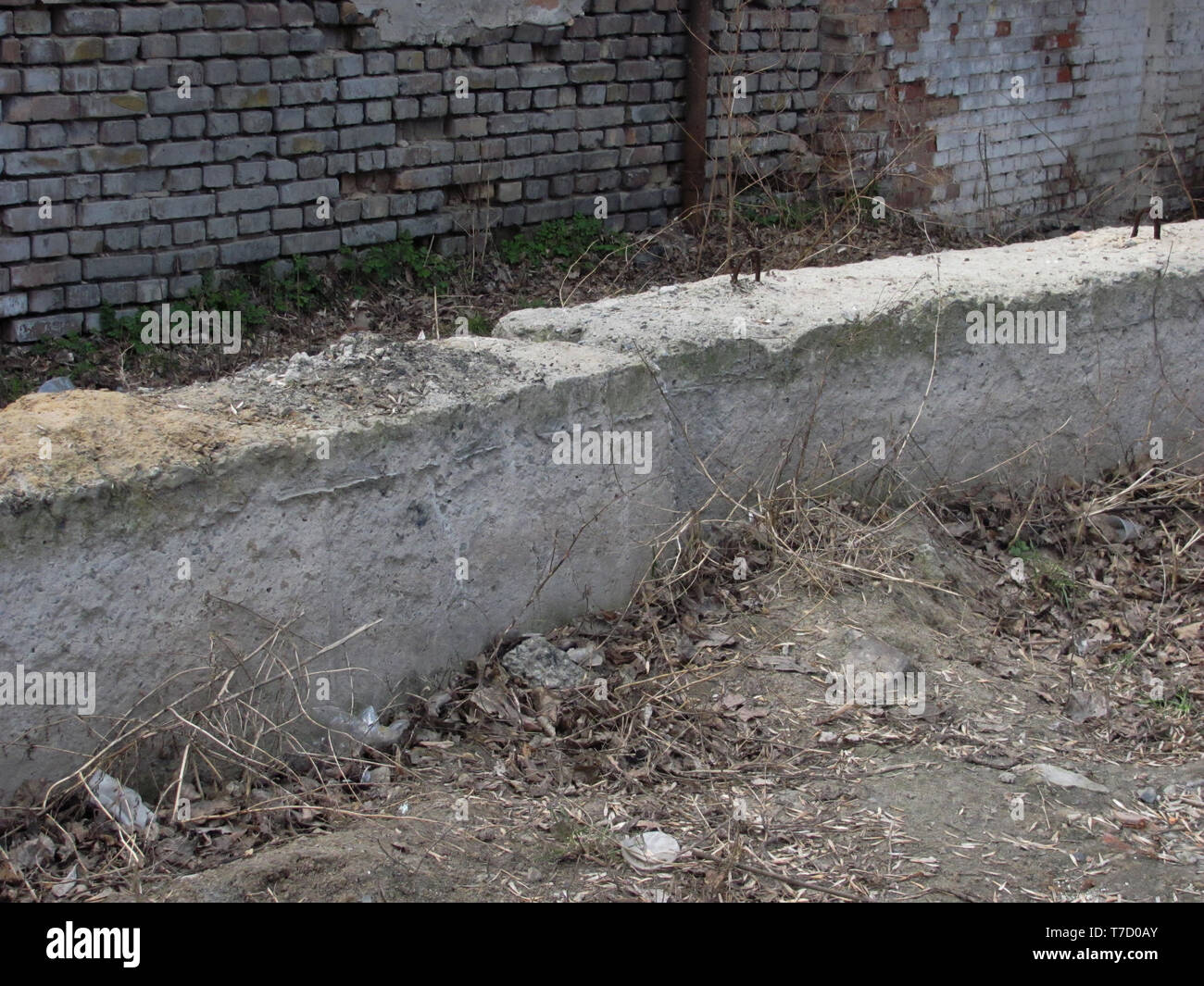 ruined brick wall, concrete blocks and ground Stock Photo - Alamy