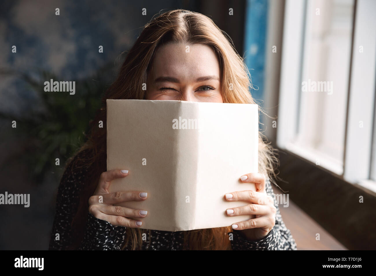 Reading book covering face hi-res stock photography and images - Alamy