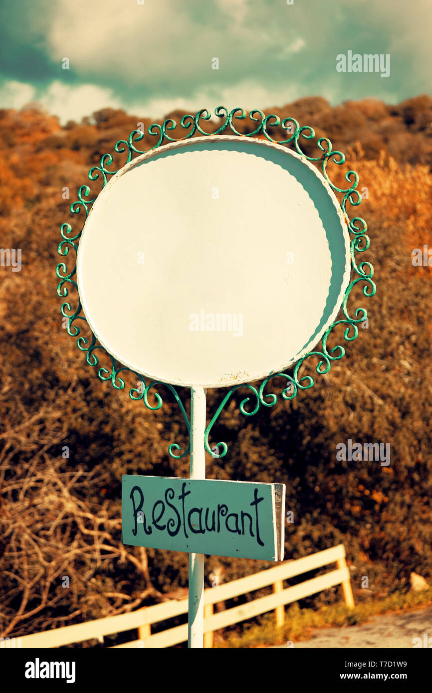 White blank oval metal sign and a wooden rectangular restaurant ...