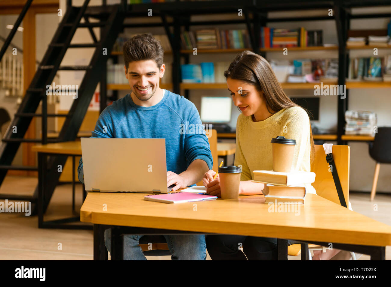 Image of a young students friends couple in library doing homework ...