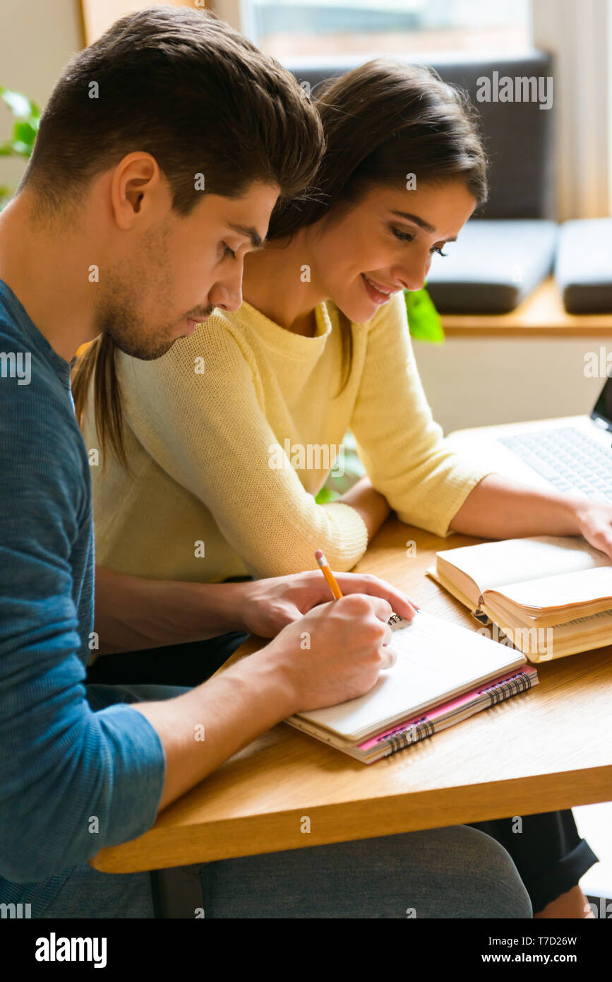 Image of a young students friends couple in library studying talking ...