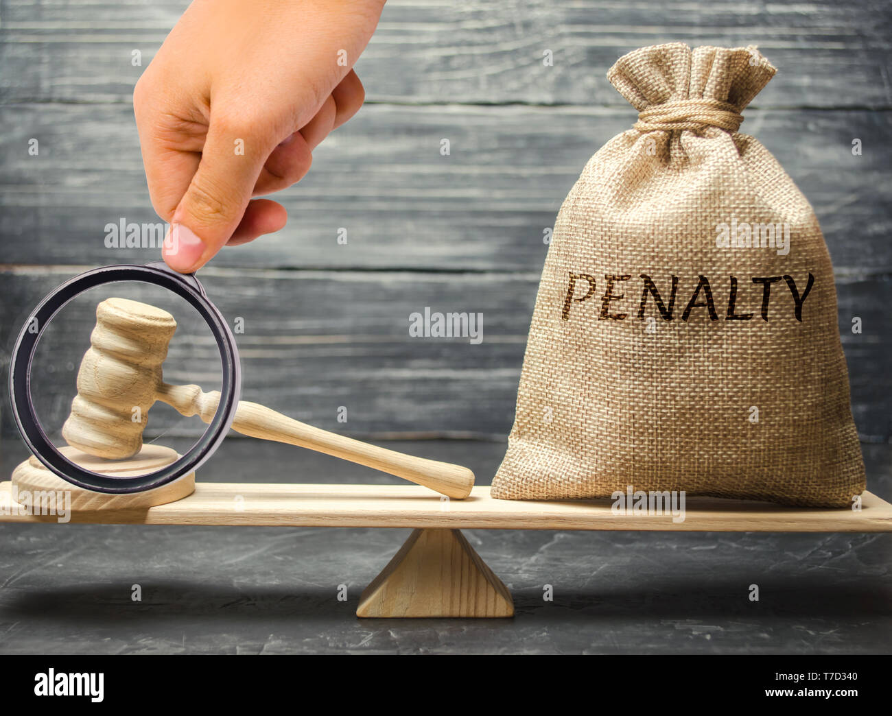 Bag with the word Penalty and gavel on the scales. Penalty as a ...