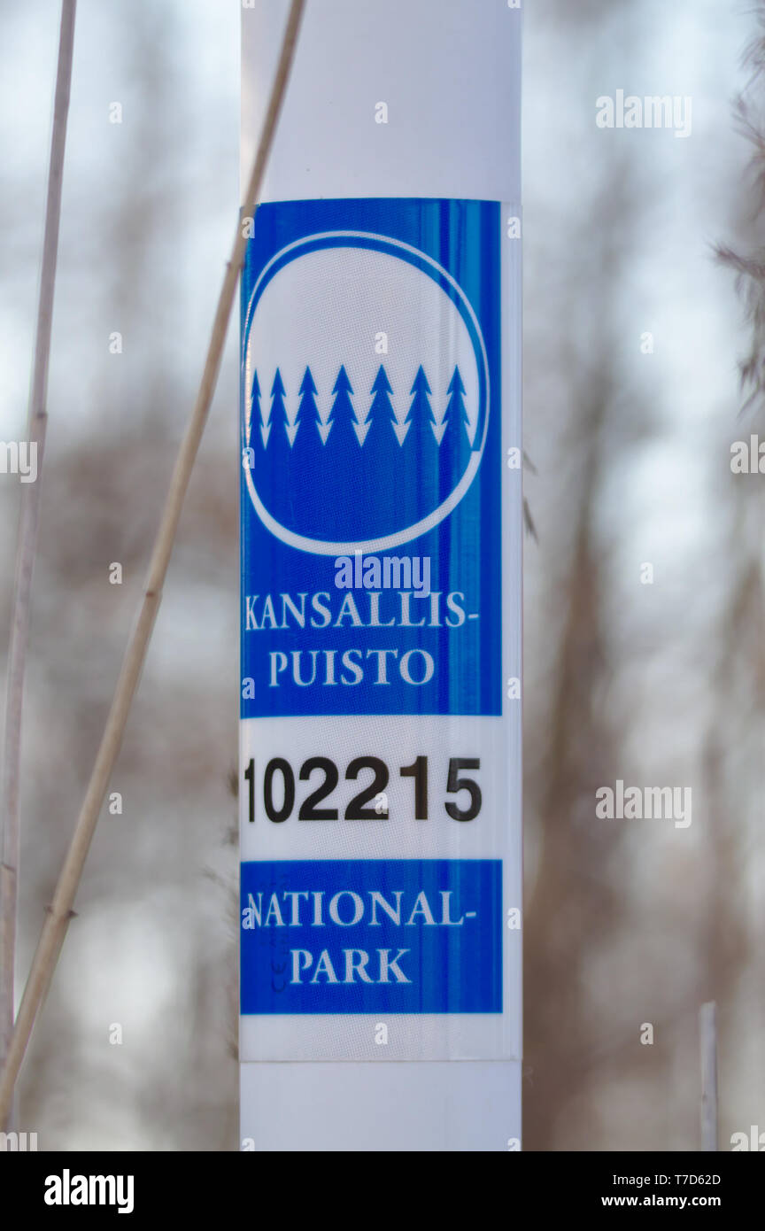Blue and white sign post of a national park. Kansallispuisto - National ...