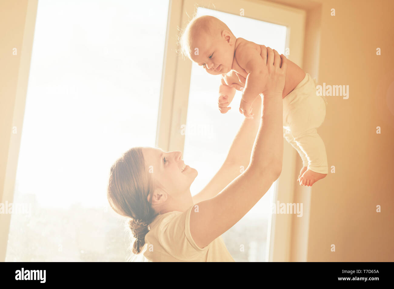 Baby laughing in mothers arms hi-res stock photography and images - Alamy