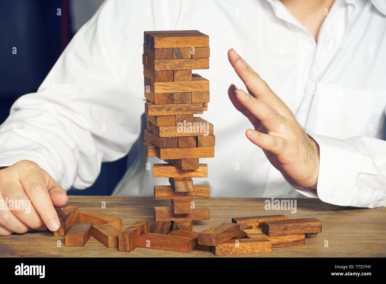 Businessman hands play wood block tower game hi-res stock photography ...