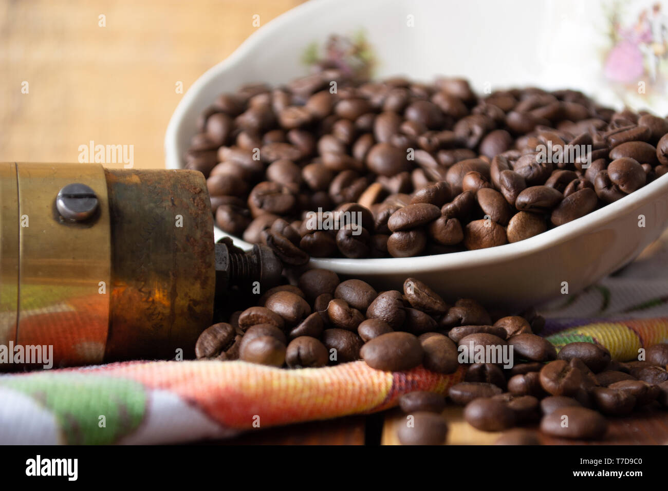 Coffee ready to be milled with old grinder. Coffee is in the table ...