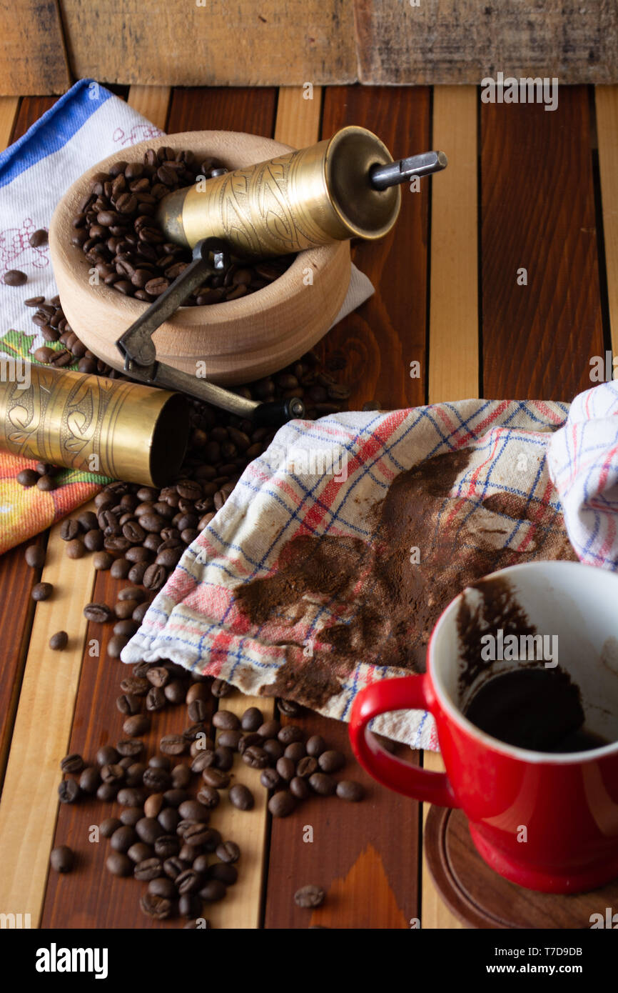 Coffee ready to be milled with old grinder. Coffee is in the table ...