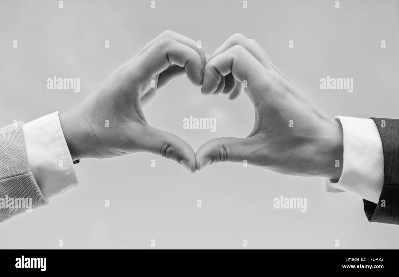 Hands put together in heart shape blue sky background. Hand heart ...