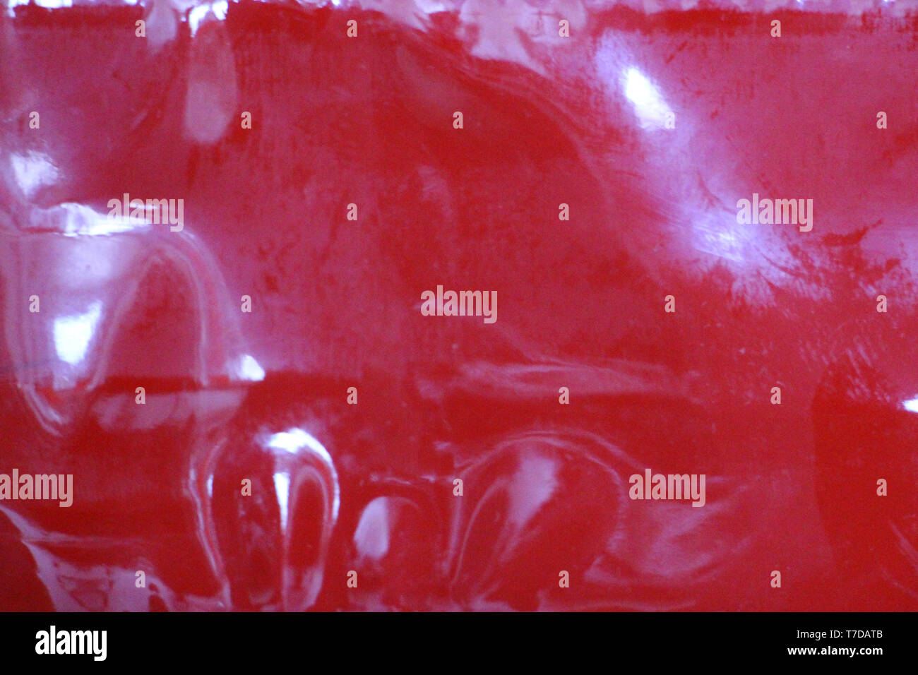 The texture of red oilcloth. Saturated red polyethylene, close-up ...